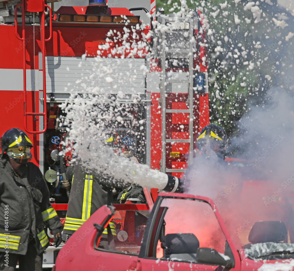 Firefighters put out the fire with white foam Stock Photo | Adobe Stock