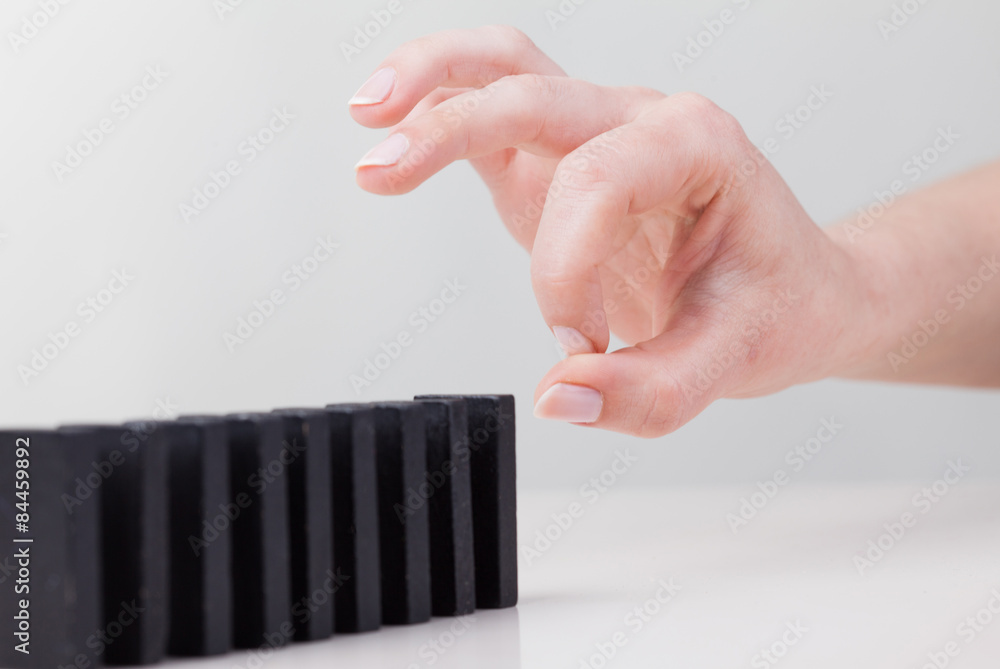 Line of dominos falling down after being pushed by finger Stock Photo ...