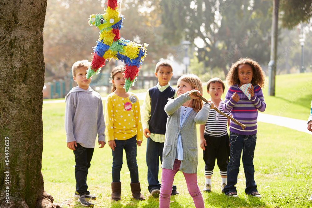 Children Hitting Pinata At Birthday Party Stock Photo | Adobe Stock