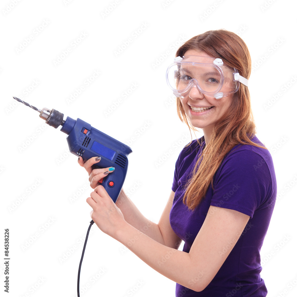 Young woman with a drill Stock Photo | Adobe Stock
