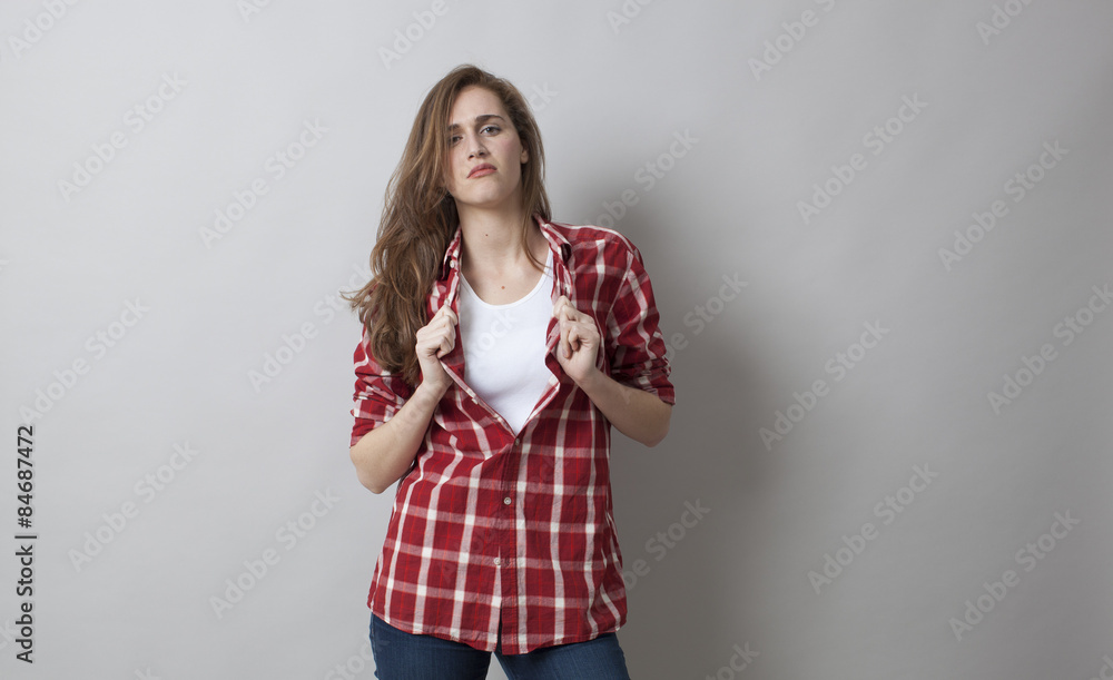 arrogant 20s girl with rolled up sleeves and boyish look Stock Photo ...