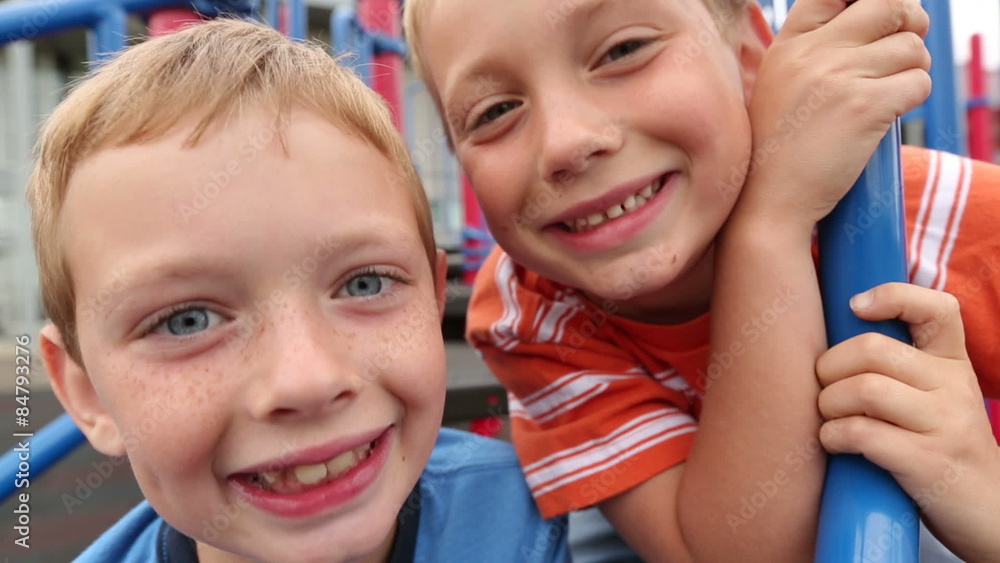 Two young boys at playground making silly faces Stock Video | Adobe Stock
