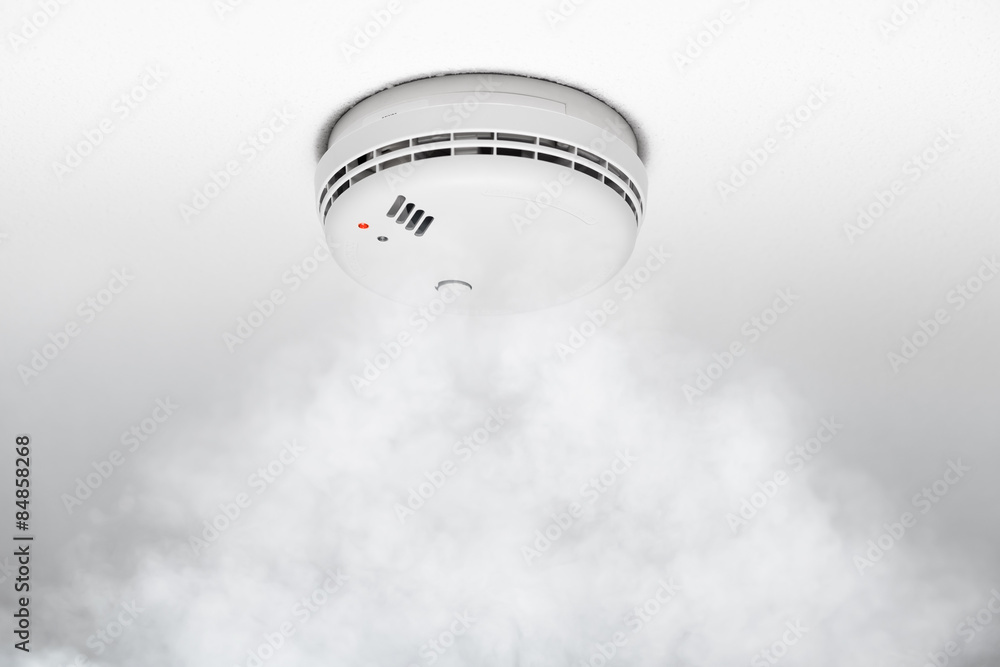 smoke detector of fire alarm in action, white background Stock Photo ...