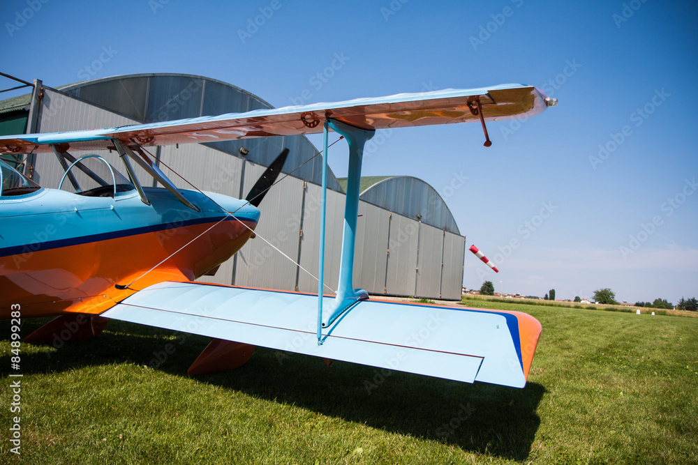 Light aircraft, modern biplane orange and blue Stock Photo | Adobe Stock