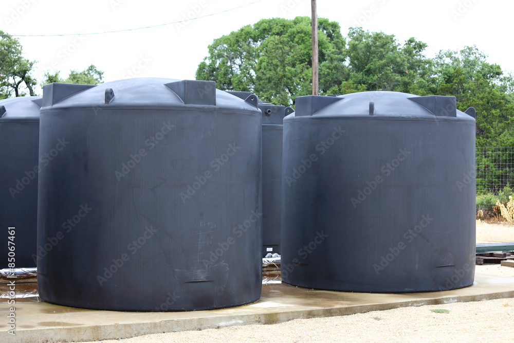 Water tanks holding rain water sit on a concrete slab. Stock Photo ...
