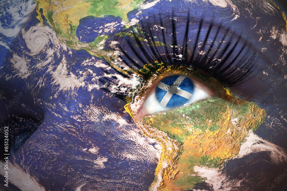 woman's face with planet Earth texture and scottish flag inside the eye ...