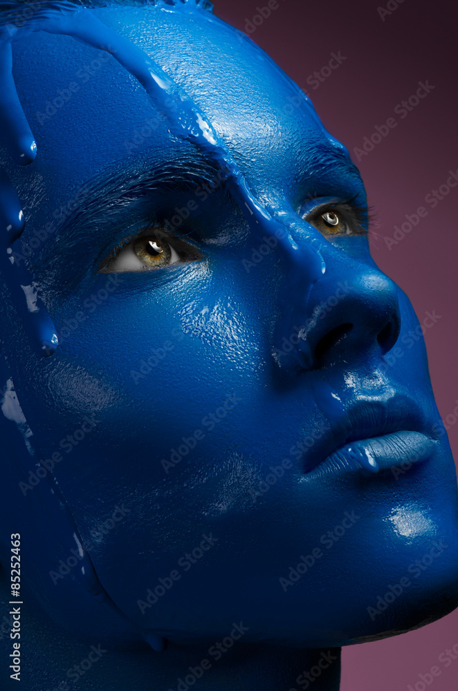 Portrait of a man poured blue paint on a pink background Stock Photo ...