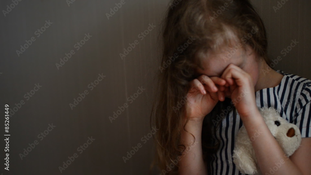 Little girl crying in the corner. Domestic violence concept. Stock ...