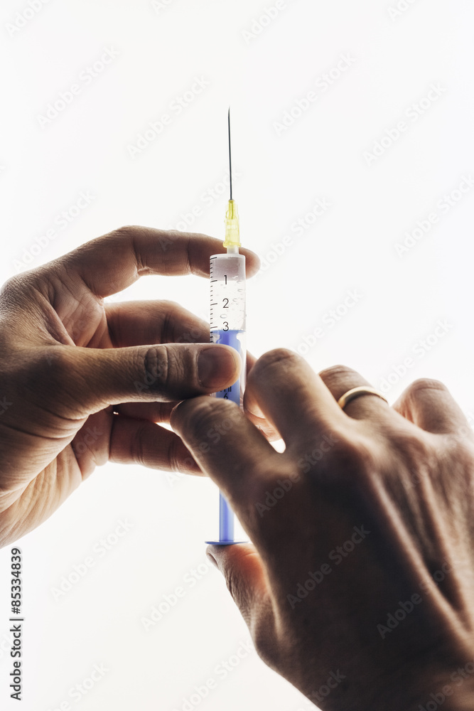 Measuring dosage with syringe Stock Photo | Adobe Stock