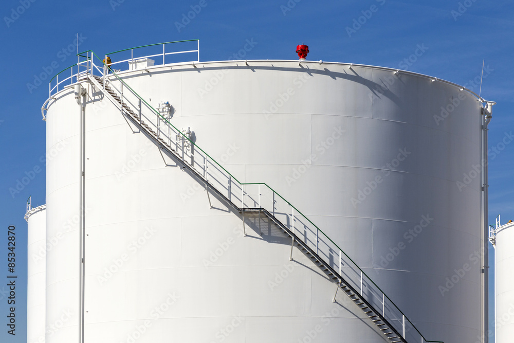 white tanks in tank farm with iron staircase Stock Photo | Adobe Stock