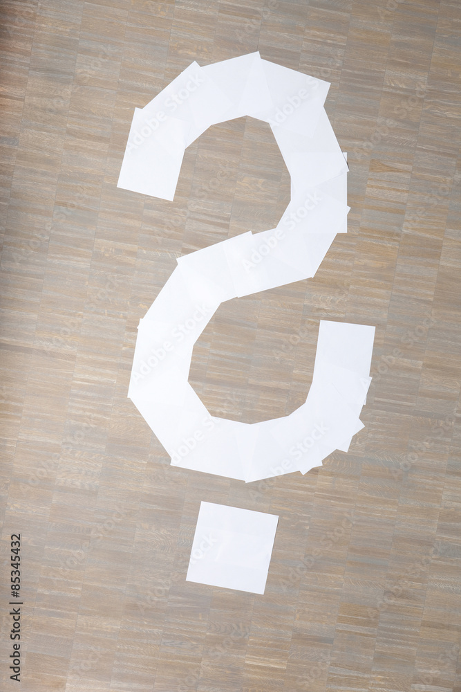 Sheets of paper in shape of question mark on floor Stock Photo | Adobe ...