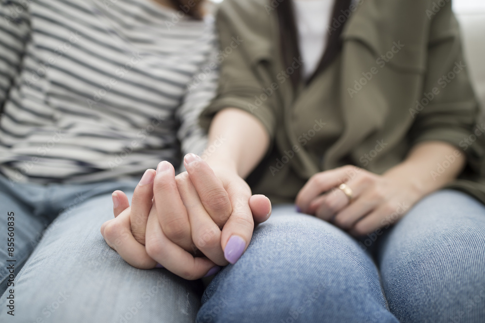 Two women holding hands Stock Photo | Adobe Stock