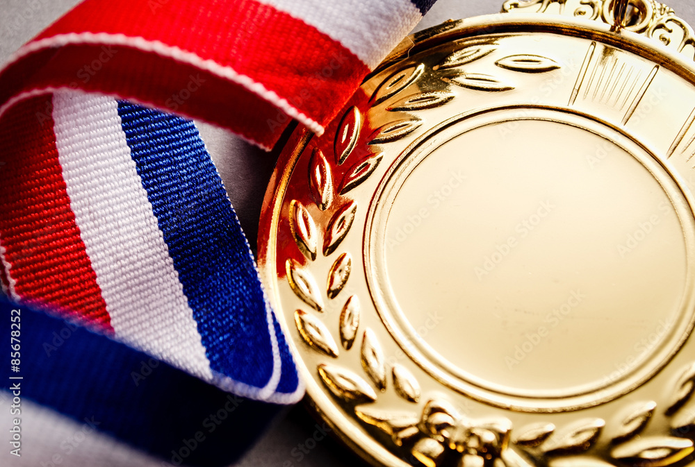 Gold medal with blank face for text, concept for winning or success ...