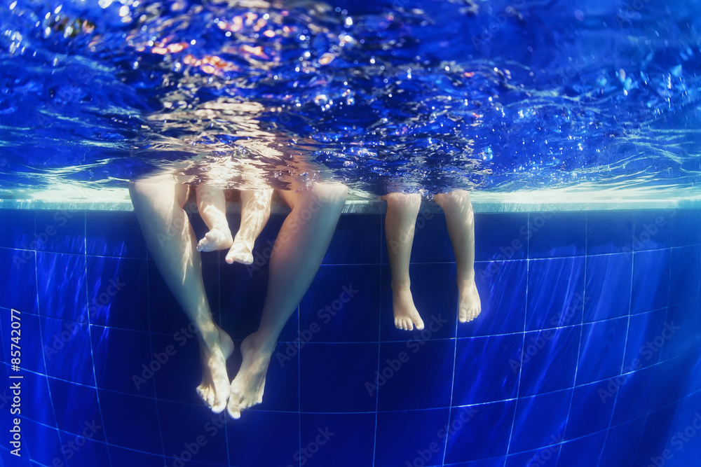 Young mother swimming underwater with fun in pool with baby boy and the ...