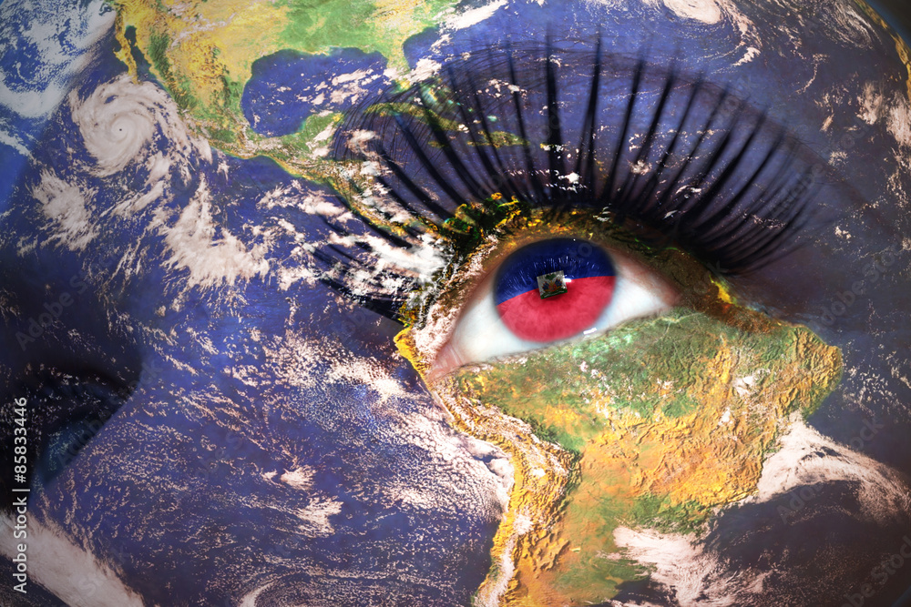womans face with planet Earth texture and haitian flag inside the eye ...