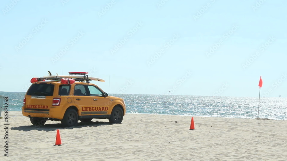 Lifeguard SUV on the beach - Yellow baywatch lifeguard vehicle parked ...