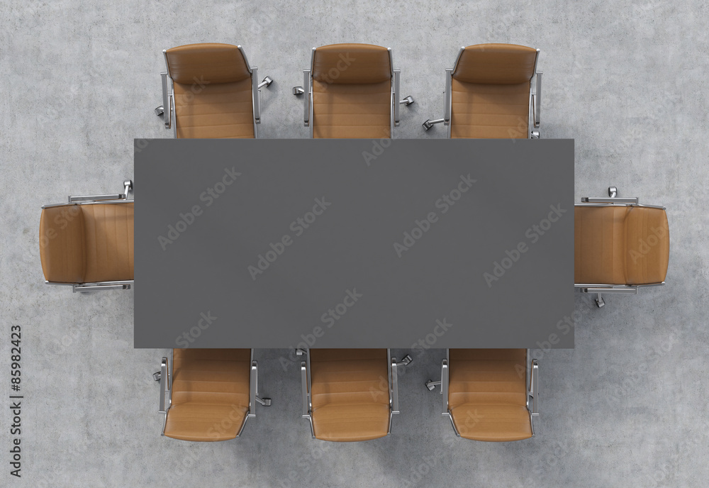 Top view of a conference room. A dark grey rectangular table and eight ...