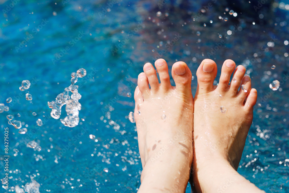 Bare woman feet splashing water in swimming pool Stock Photo | Adobe Stock