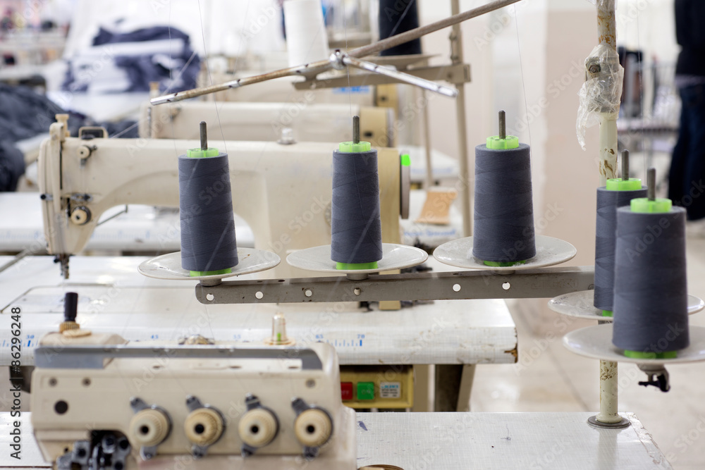Tailors working in the sewing workshop using tailoring machine Stock ...