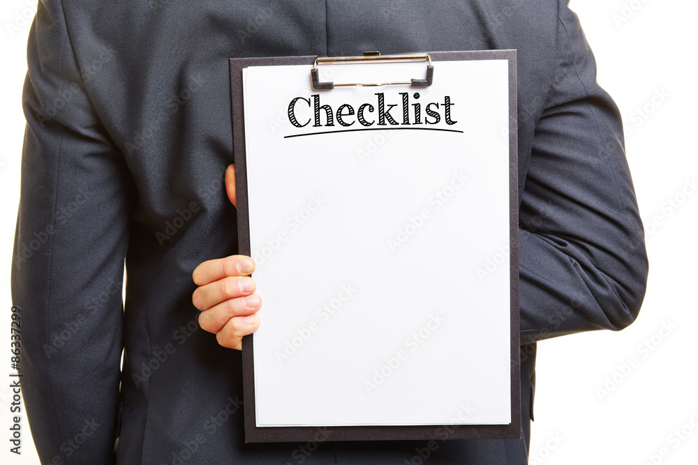 Hand holding checklist on clipboard Stock Photo | Adobe Stock