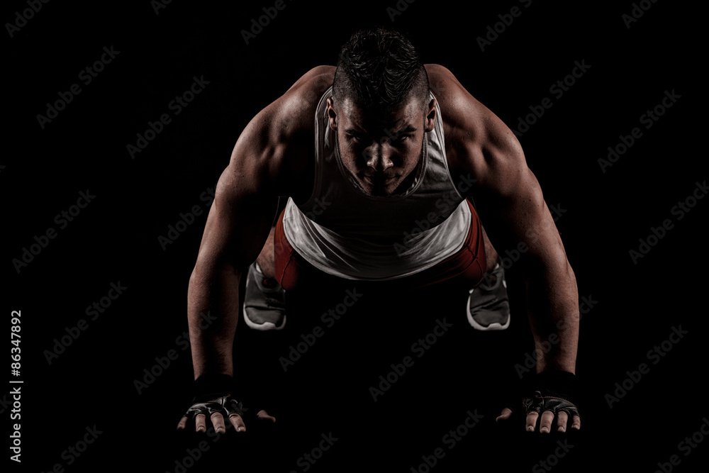 Bodybuilder posing on black background. Stock Photo | Adobe Stock