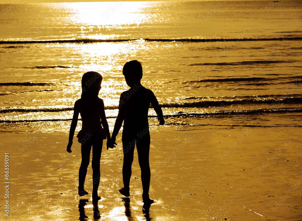 Silhouette boy and girl on the sea Stock Photo | Adobe Stock