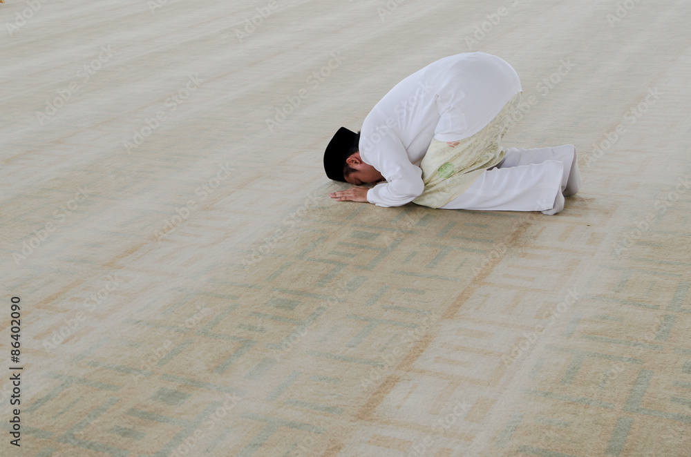 man praying, man prostrating during prayers Stock Photo | Adobe Stock