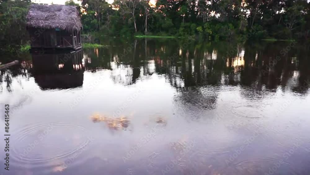 Yanayacu river passing by a floating building in the Amazon rain forest ...