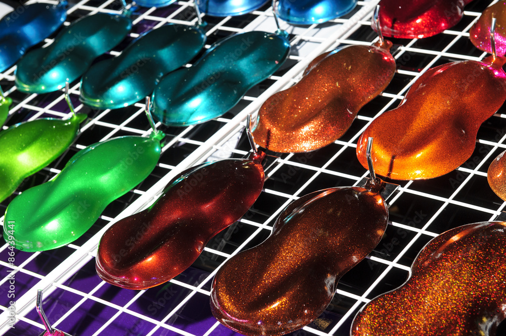 Car metallic paint samples, stand with examples of glowing colors ...