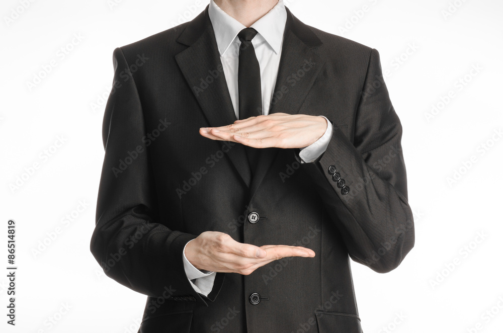 Businessman and gesture topic: a man in a black suit and tie holding ...