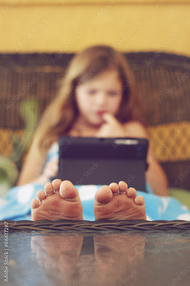 cute little girl reading on a device 5 Stock Photo | Adobe Stock