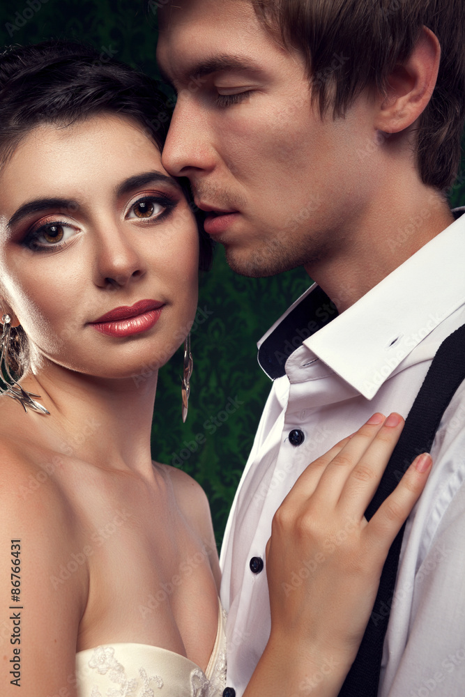 Gourgeous bride in wedding dress kissed by groom Stock Photo | Adobe Stock