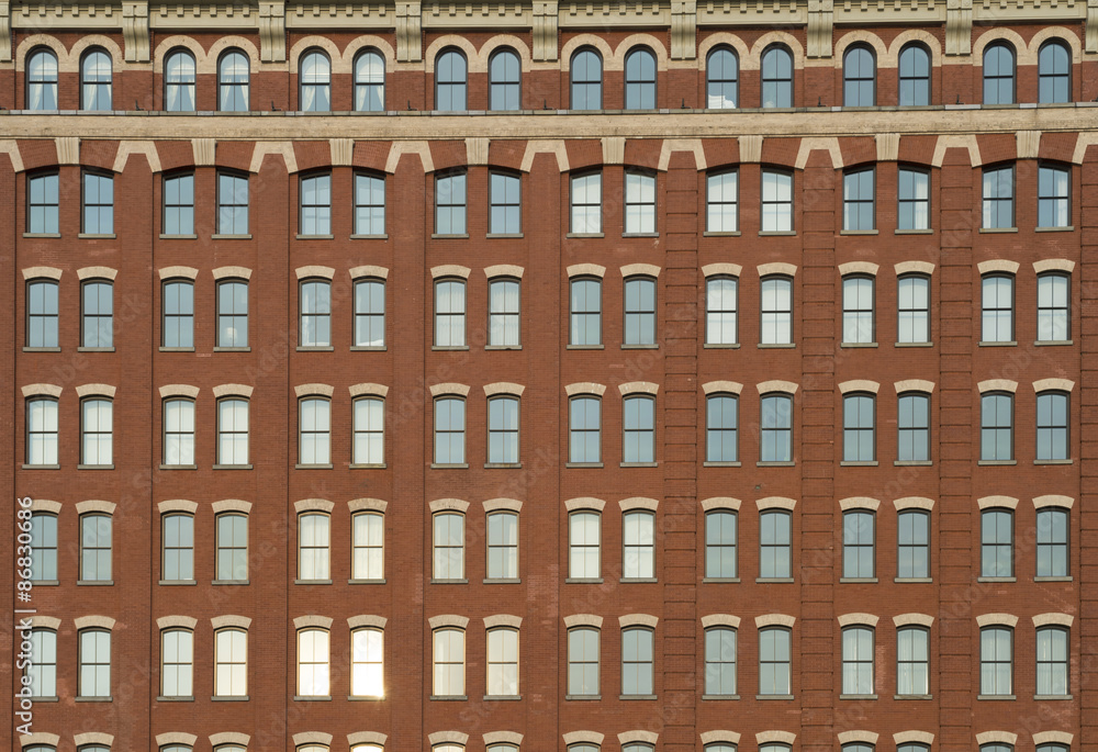 Traditional brick architecture skyscraper with arched window details ...
