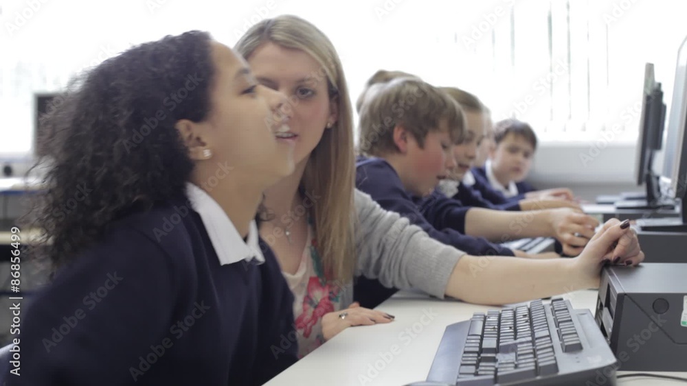 Teacher Helping Female Pupil In Computer Class Stock Video | Adobe Stock