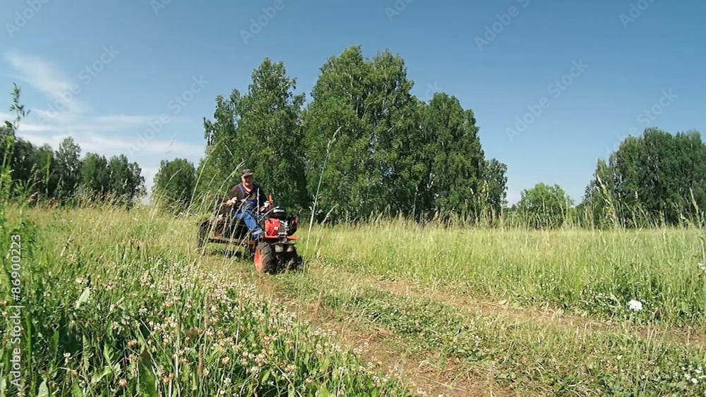 Farmer is riding on the behind tractor along a dirt road Stock Video ...