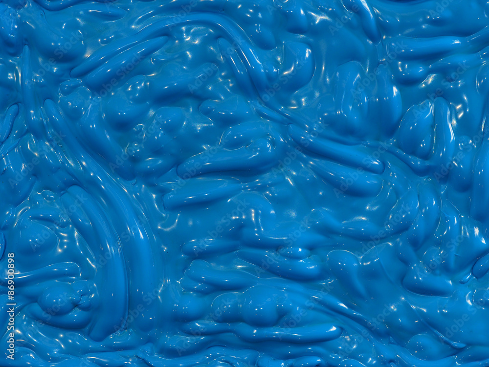 A blue polymer mass with a flat wave, dough or mud like structure in ...