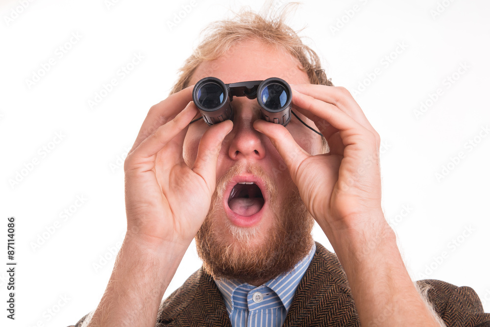 Foto de Shocked man watching through binoculars do Stock | Adobe Stock