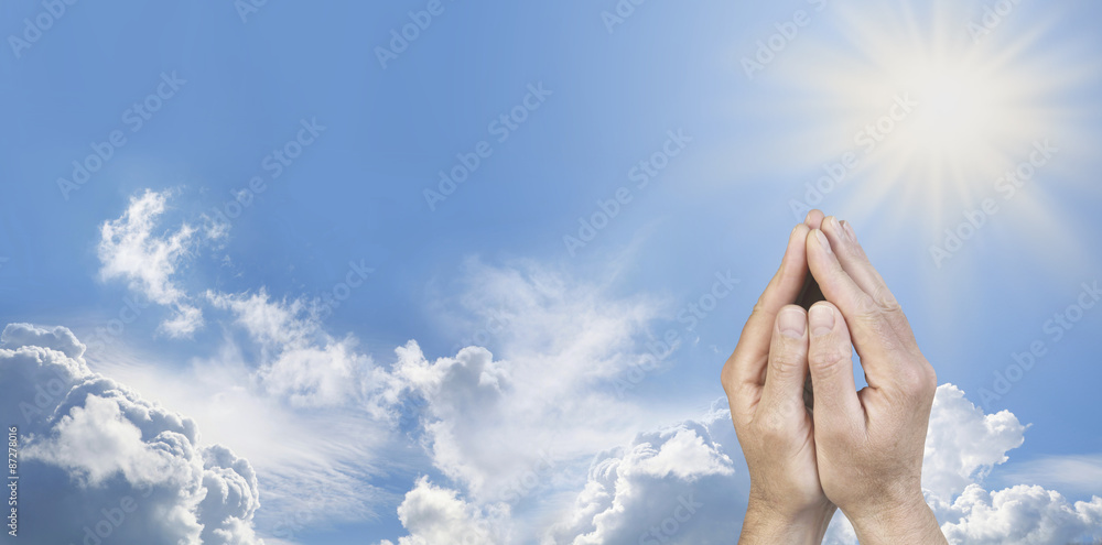 Cupped Hands in Prayer Position - Males hands cupped together in prayer position on a wide sunny ...