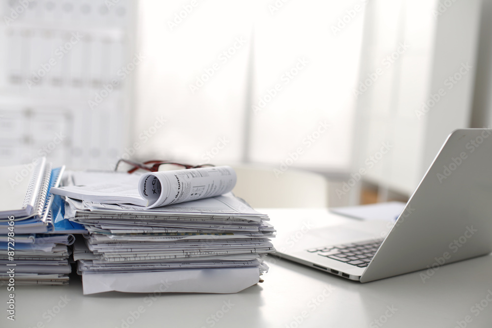 Foto de office desk a stack of computer paper reports work forms do ...