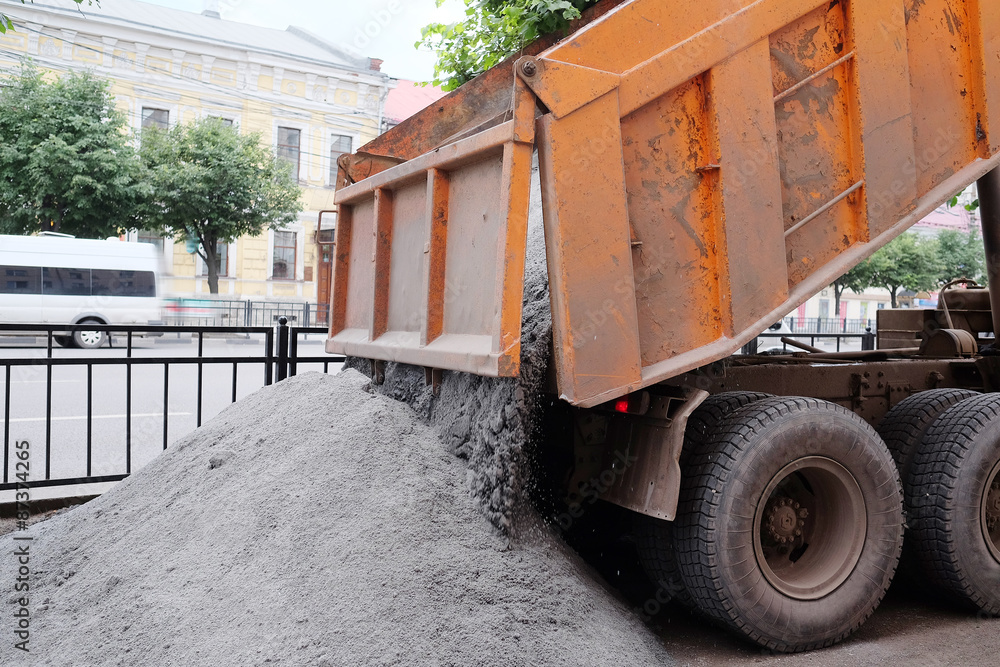The dump truck pours out cement on the repaired sidewalk Stock Photo ...