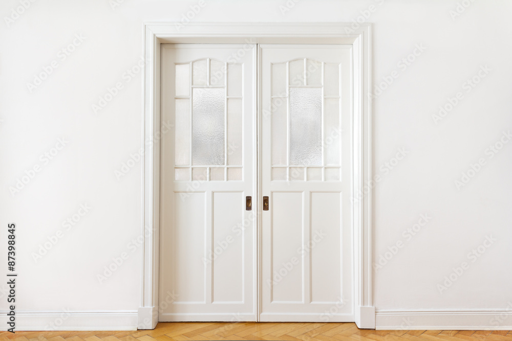 White wall with a double sliding door or pocket doors with textured ...