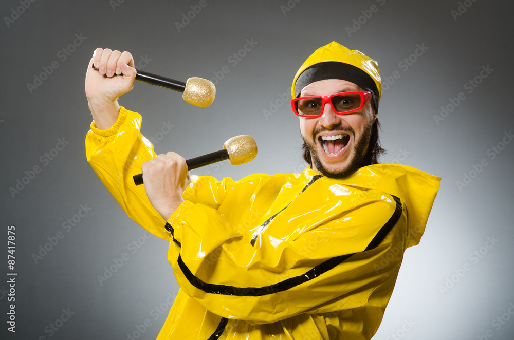Man wearing yellow suit with mic Stock Photo | Adobe Stock