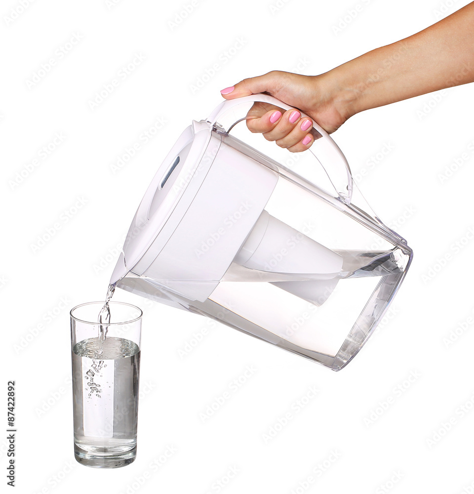 hand holding water filter jug and pouring water into a glass iso Stock ...