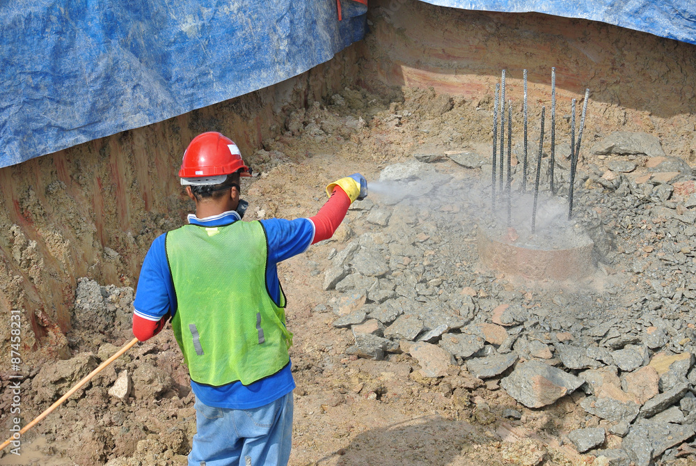 Construction workers sraying the anti termite chemical treatment to the ...