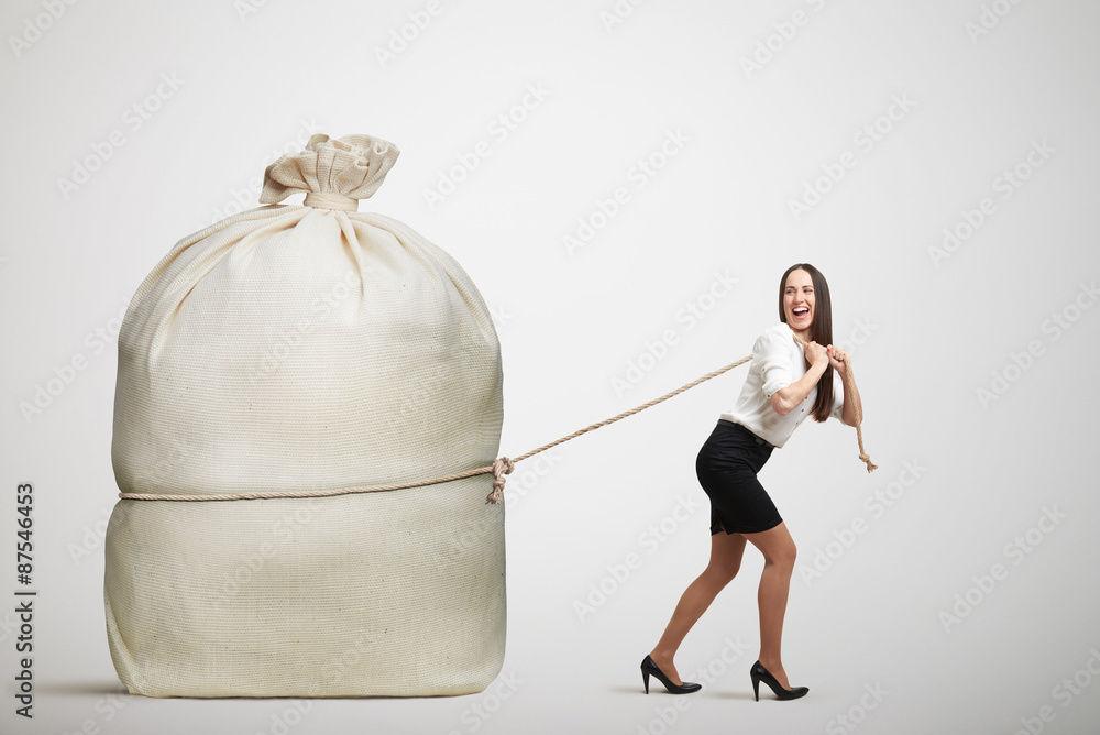 woman pulling big bag Stock Photo | Adobe Stock