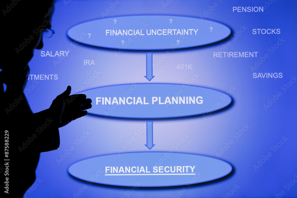 Silhouetted man presenting a financial planning chart on an LCD screen ...