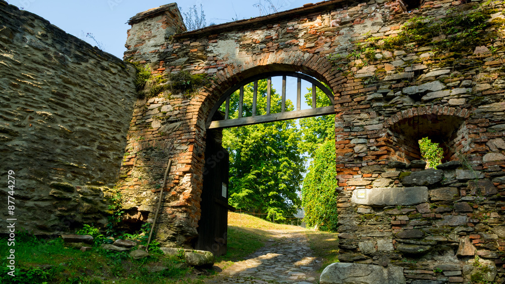 Illuminated brick and stone walls with open gates Stock Photo | Adobe Stock