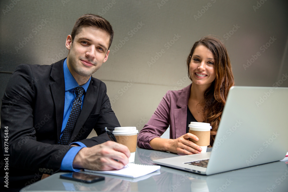 Two executives working late on a computer at a desk CEO boss with ...