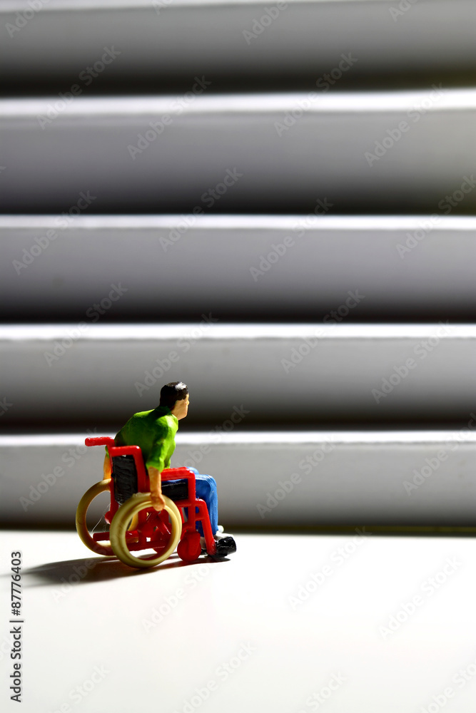 Miniature man wheelchair access concept. Miniature scale model figure ...