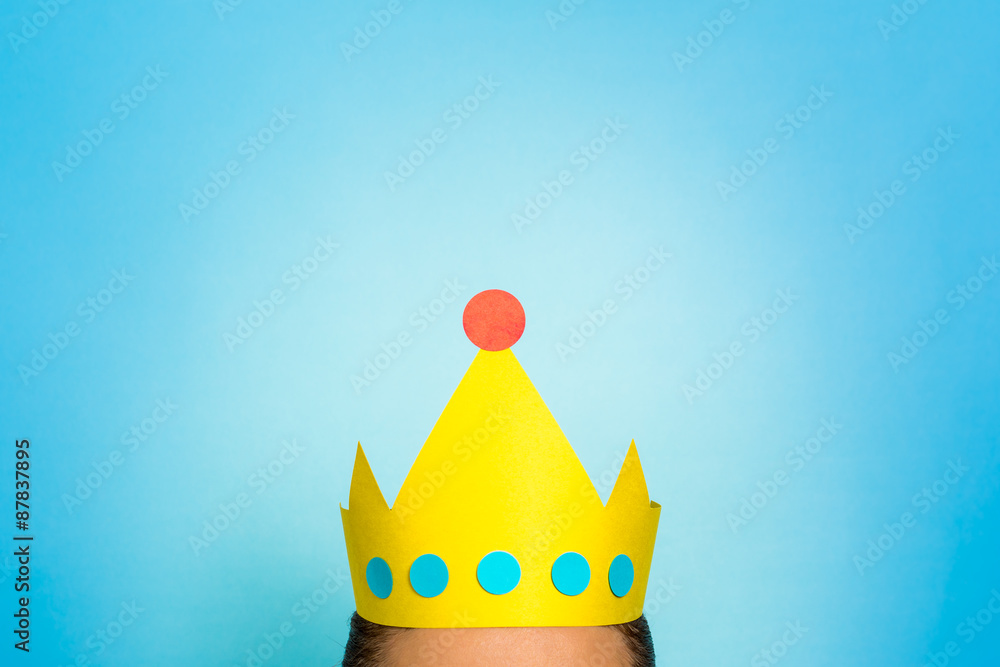 Woman wearing papercraft golden yellow crown. Stock Photo | Adobe Stock